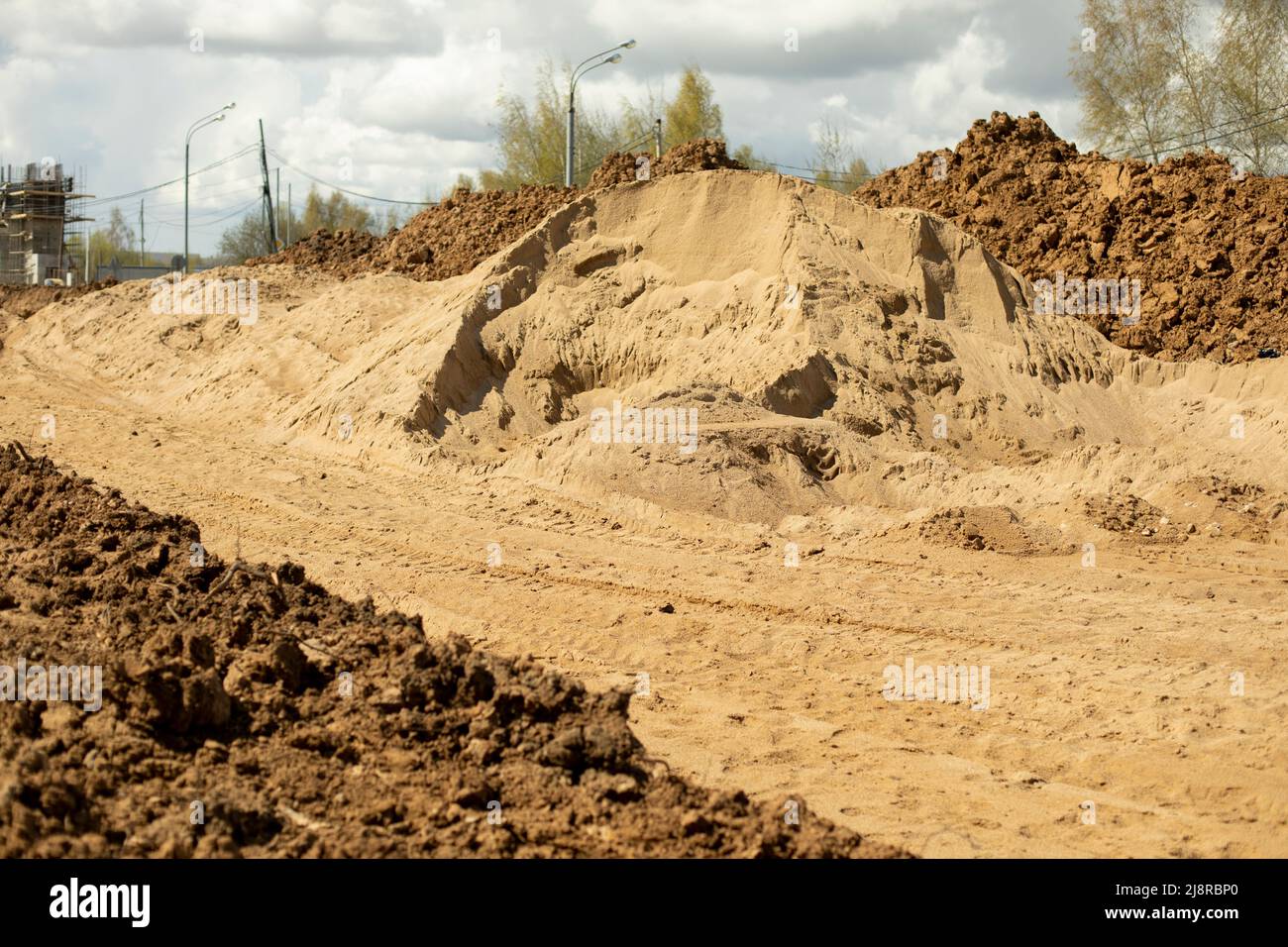 Construction sand. Mountain of sand on construction site. Excavated ...