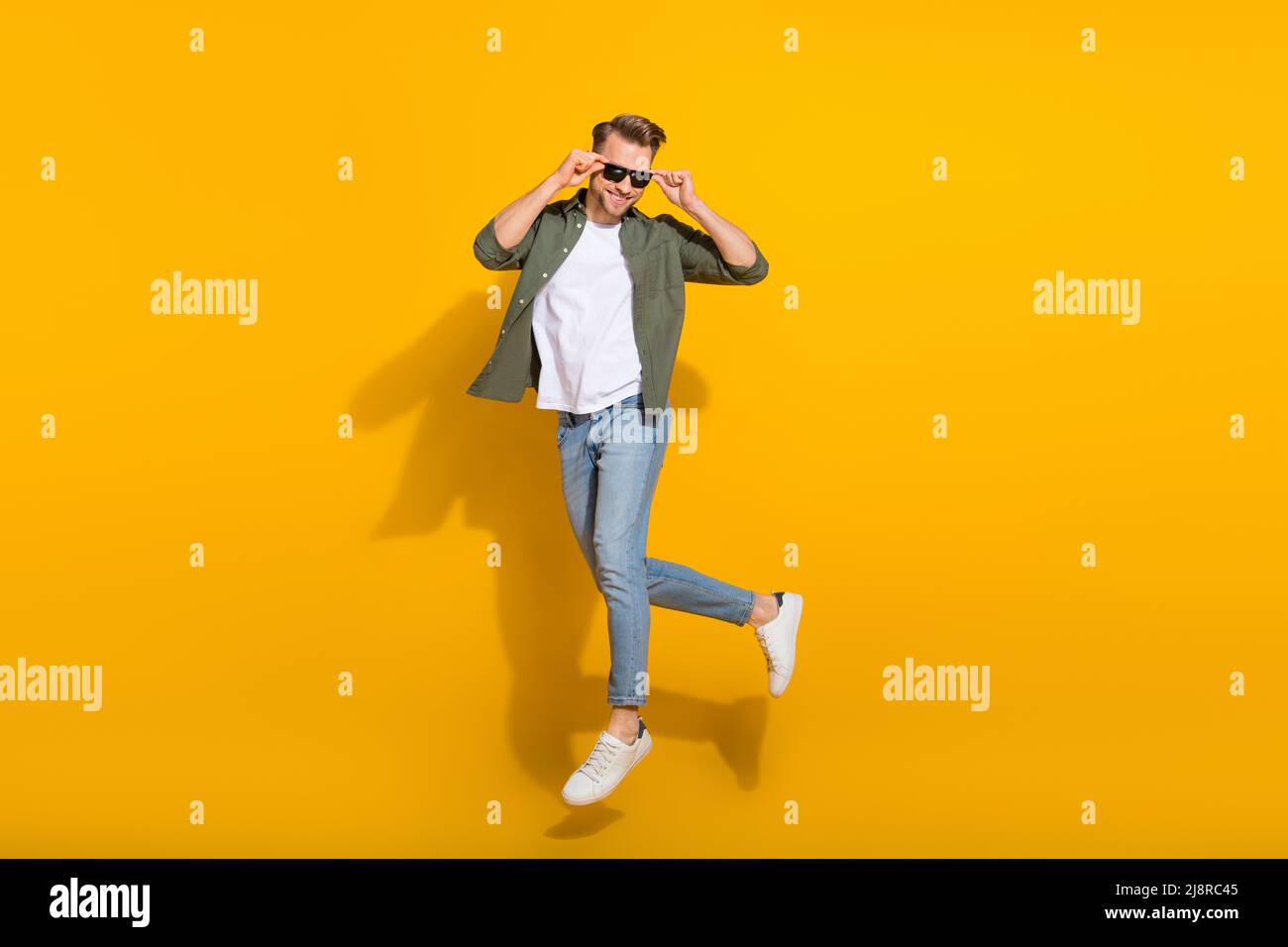 Full length body size view of attractive cheerful guy jumping touching ...