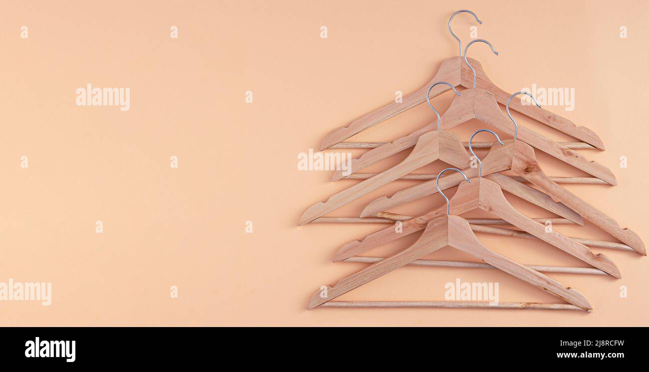 Hangers for clothes. Hanger set. Beige background copy space banner ...