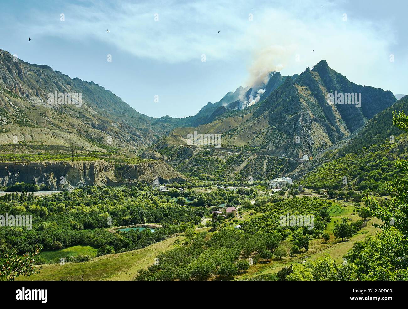 Fire in the mountains, big mountain formation in the background ...