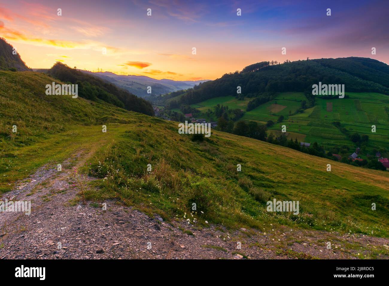 mountainous countryside landscape at dawn. rural fields on the hills ...