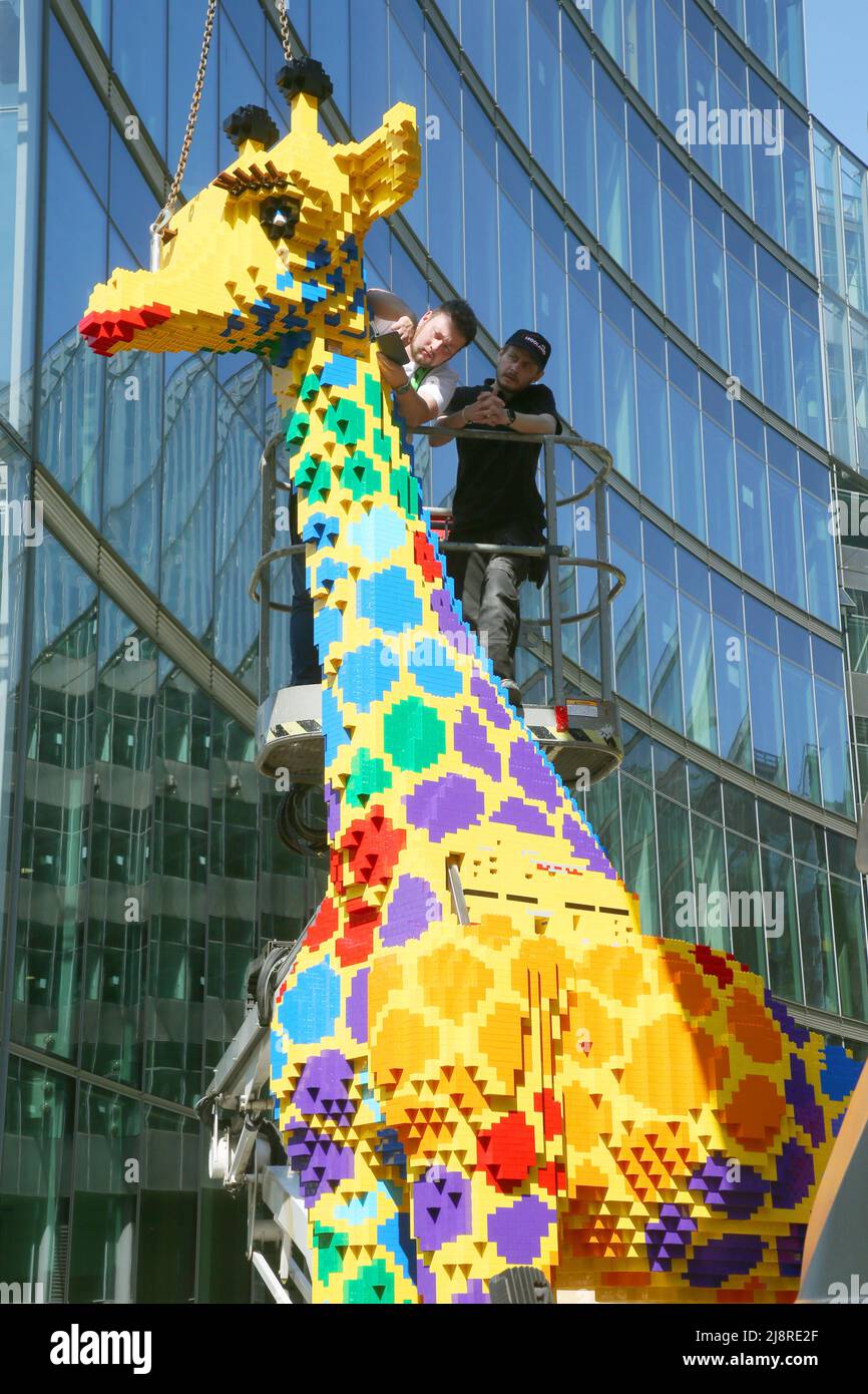 Berlin, Germany. 18th May, 2022. Men use a crane to erect a new Lego ...