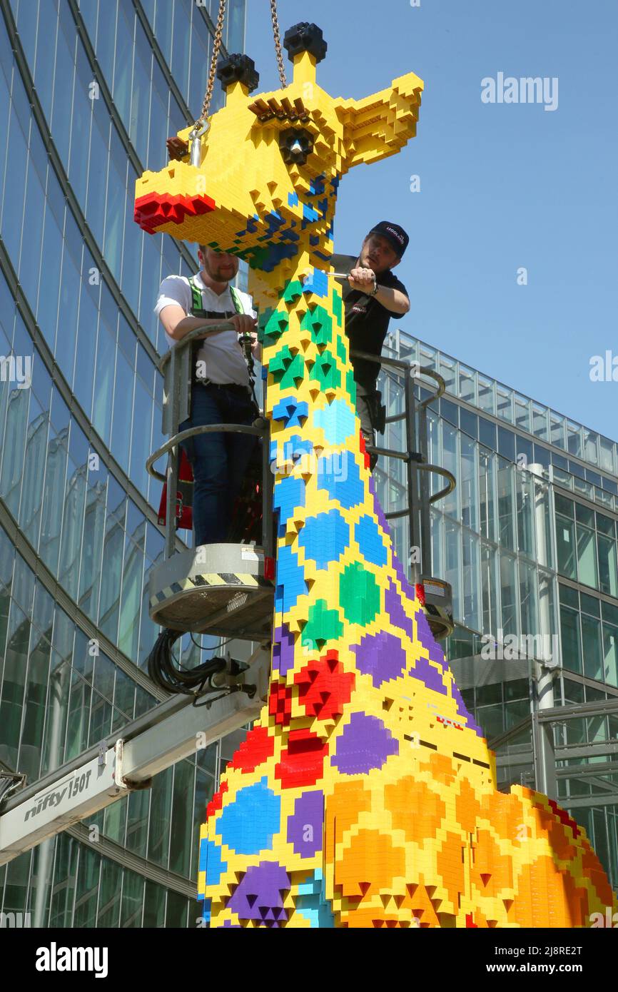 Berlin, Germany. 18th May, 2022. Men use a crane to erect a new Lego ...