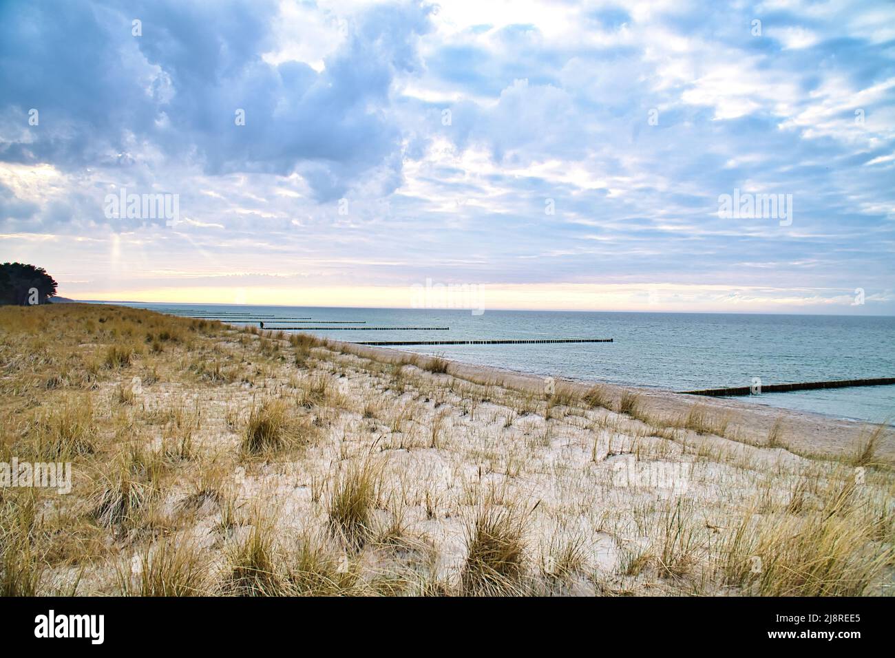 View over the dunes to the Baltic Sea at sunset. Vivid colors in the ...