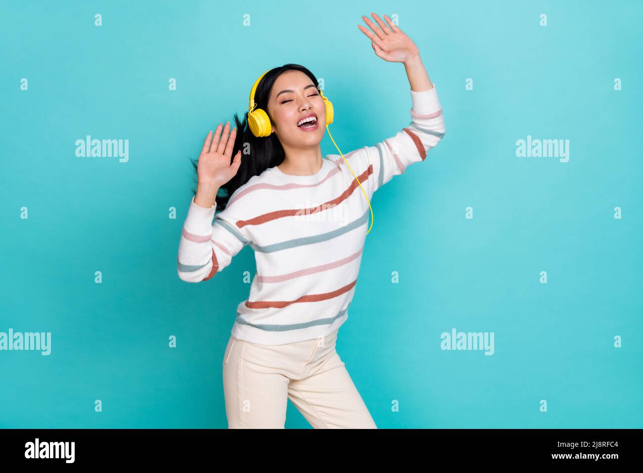 Photo of sweet young lady listen music dance wear headphones pullover ...