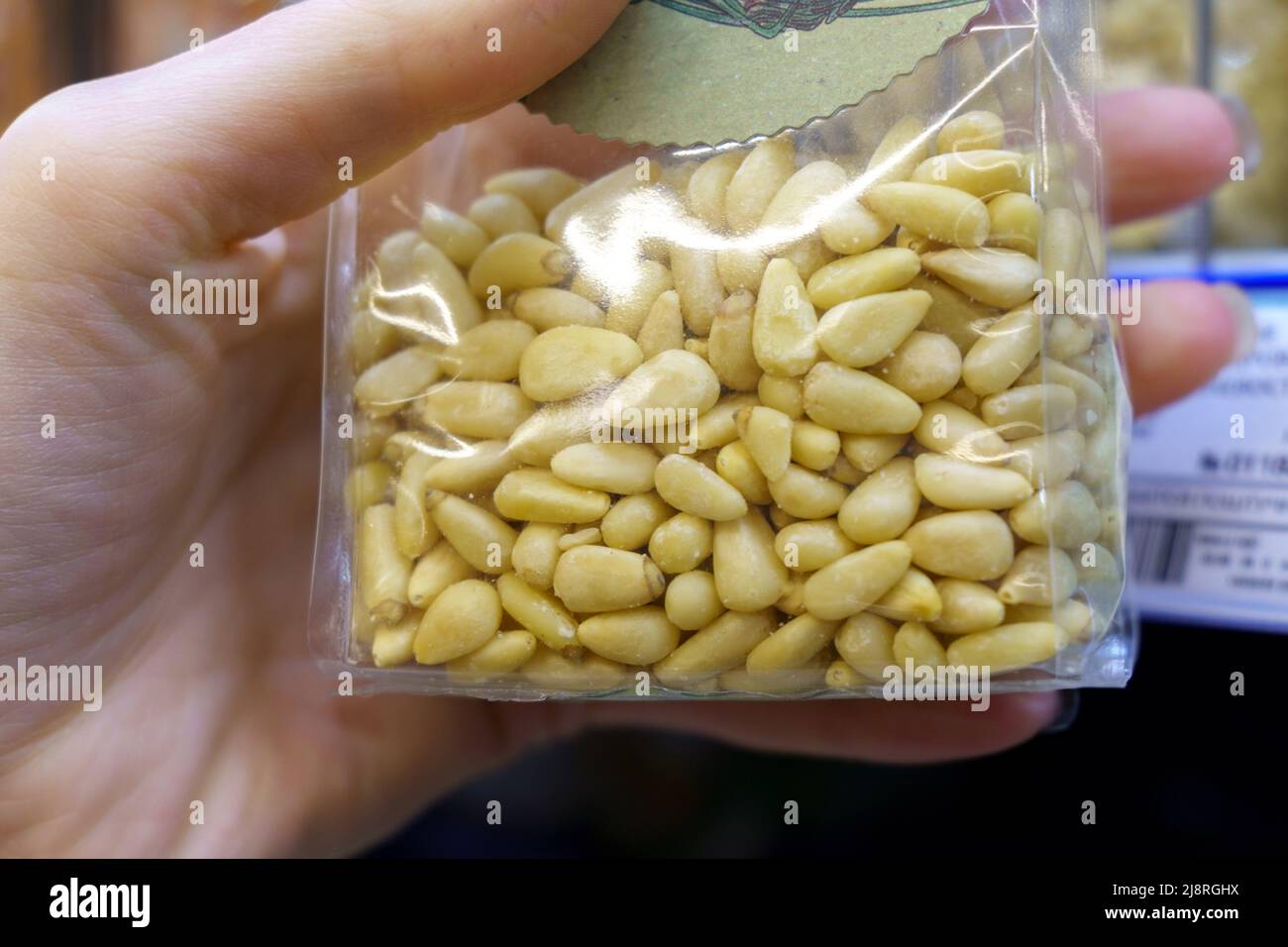 Packaged snacks pine nuts on the shelves of the hypermarket. A healthy ...
