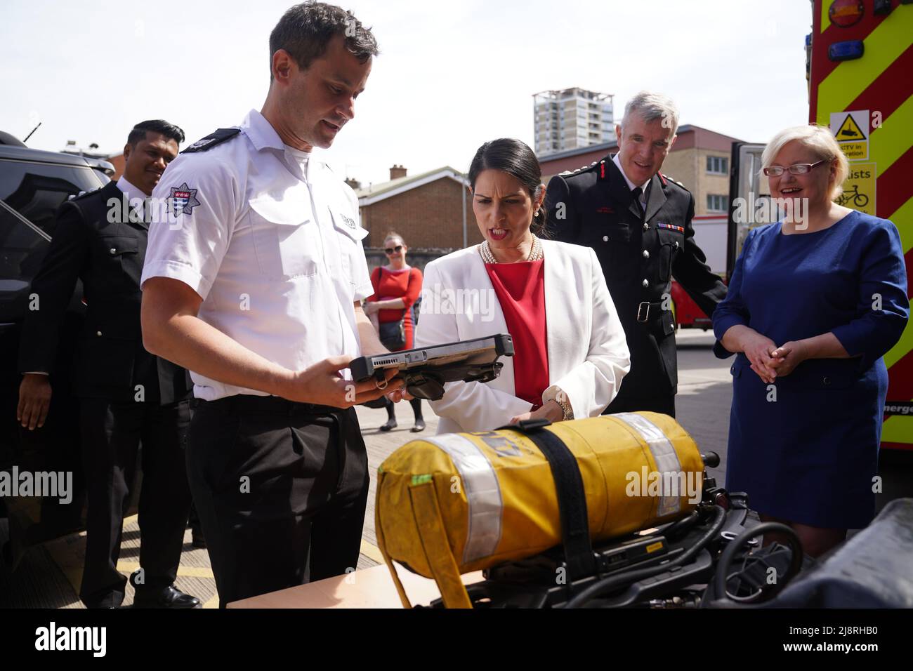 Home Secretary Priti Patel (centre) is shown equipment with London Fire ...