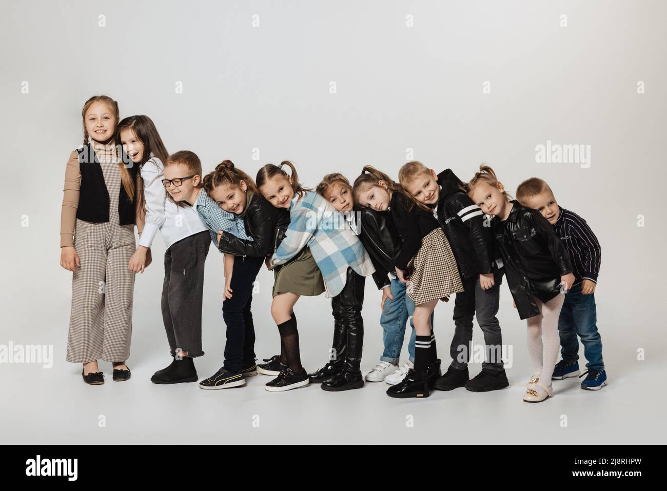 Group of happy cute kids, little girls and boys in modern outfits ...