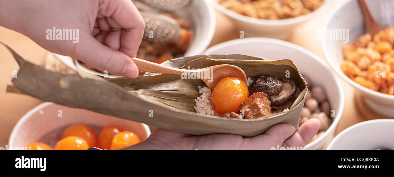 Making zongzi food - preparing and wrapping Chinese rice dumpling at ...