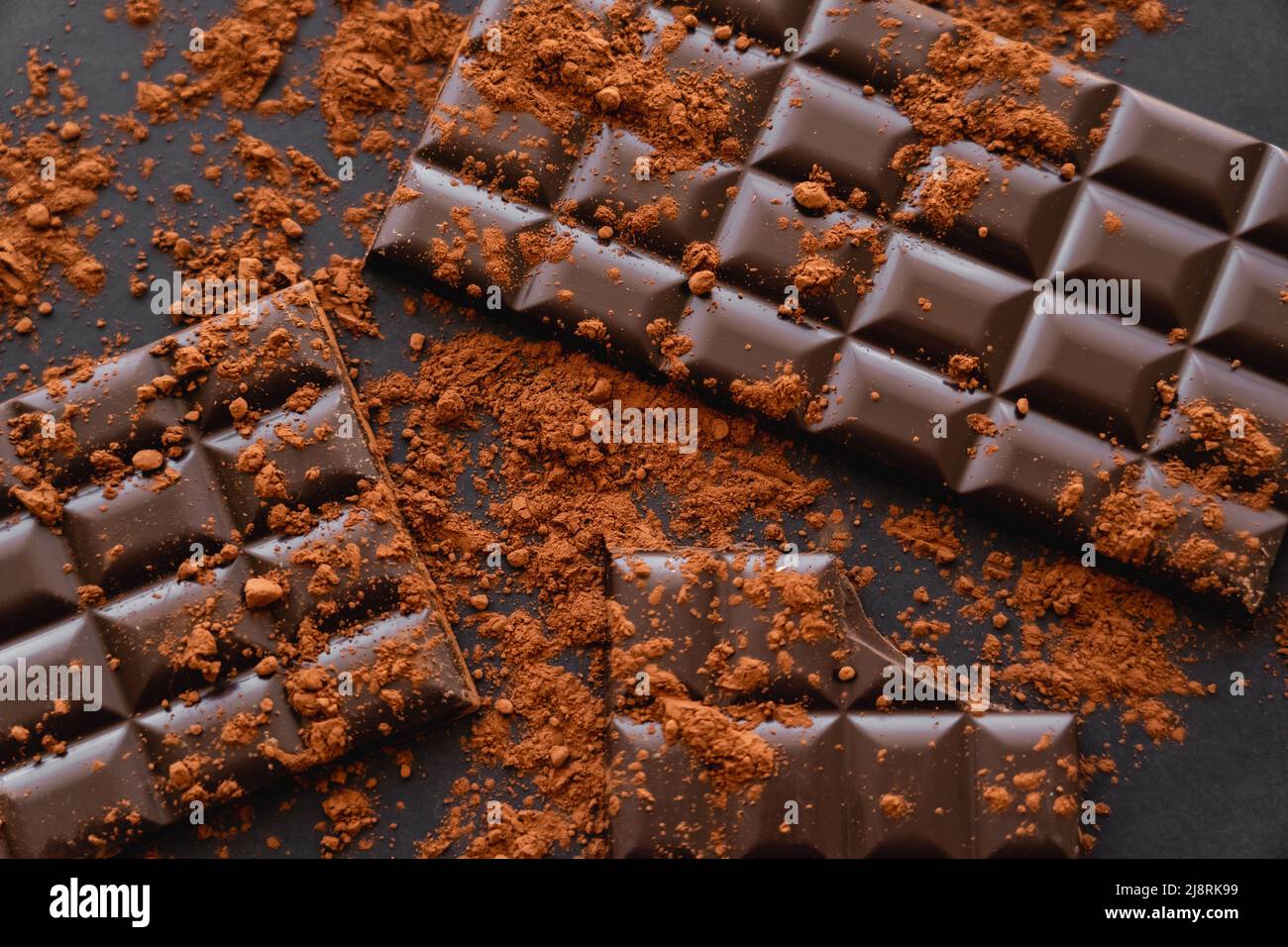 Top view of natural cocoa and chocolate bars on black background Stock ...