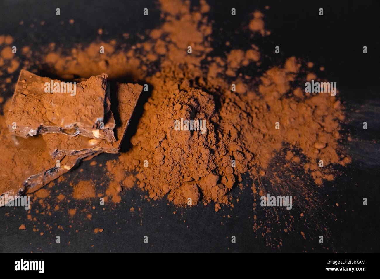 Top view of chocolate and cocoa powder on black surface Stock Photo - Alamy