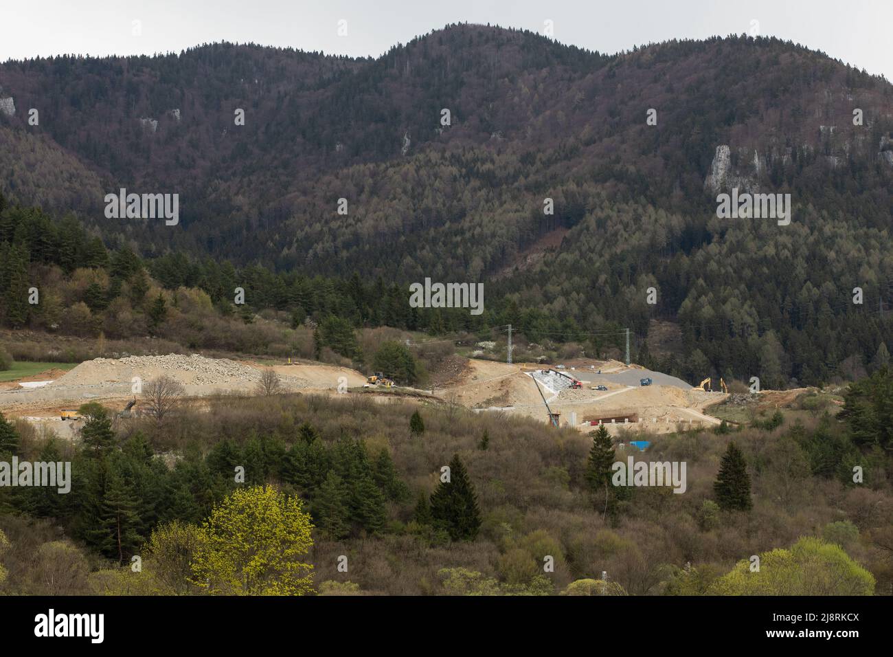 Highway construction works on steep mountain slope. High quality photo ...