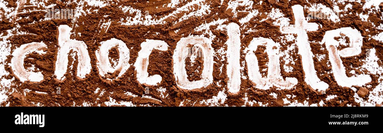 Top view of chocolate lettering in cocoa powder on white background ...