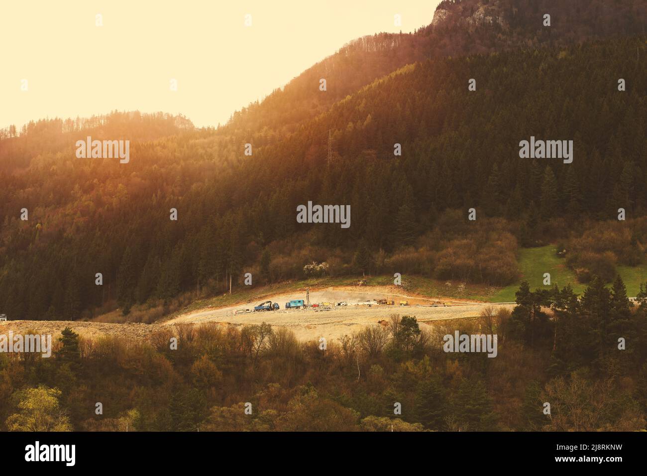 Highway construction works on steep mountain slope. High quality photo ...