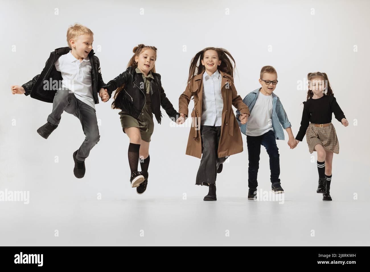 Happy school and preschool age children, girls and boys running ...
