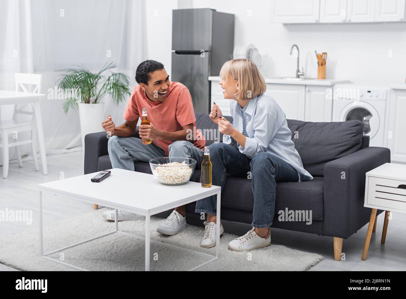 Excited multiethnic couple cheering hi-res stock photography and images ...