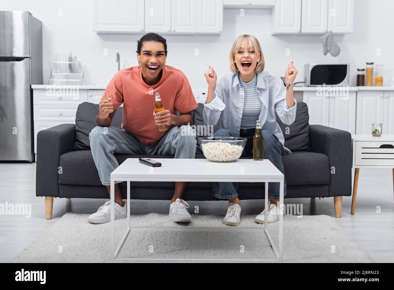 Excited multiethnic couple cheering hi-res stock photography and images ...