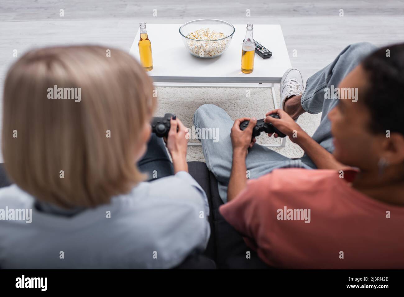 KYIV, UKRAINE - DECEMBER 6, 2021: popcorn and beer near multiethnic ...