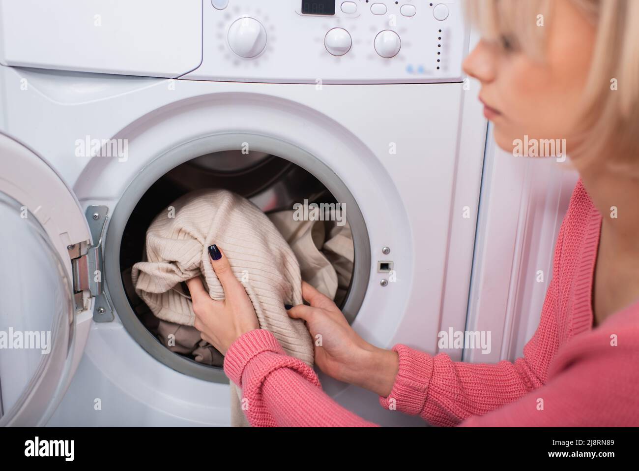 Woman putting clean clothes hi-res stock photography and images - Alamy