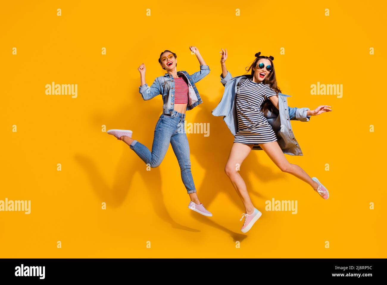 Full body portrait of two pretty cheerful people jumping good mood ...
