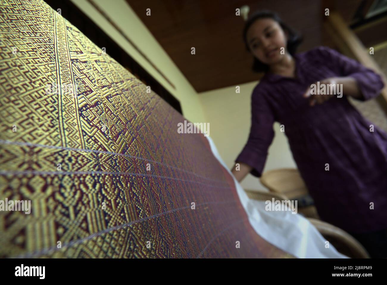 A high-profile songket fabric with golden yarn at Erika Rianti songket ...