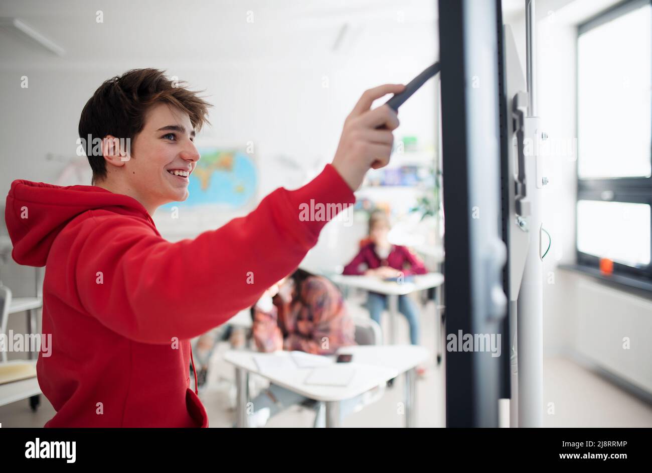 College student explaining some ideas on a touch TV in classroom Stock ...