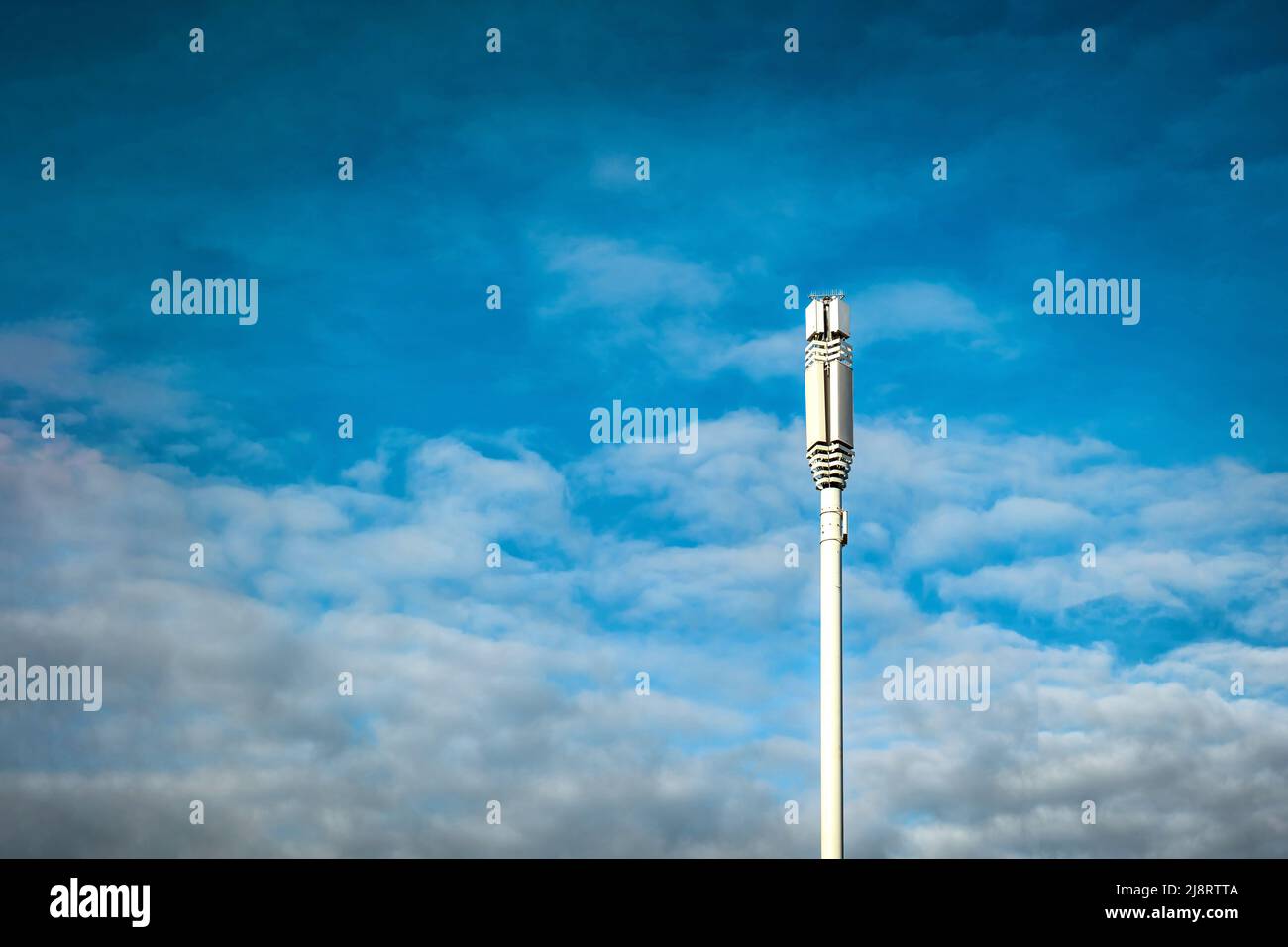 british mobile network operator mast over the blue sky Stock Photo - Alamy