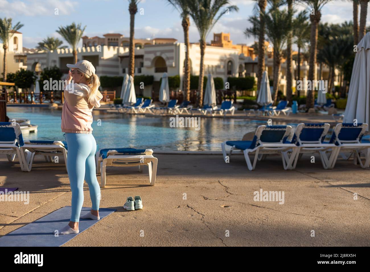 Good morning with yoga meditating on sunrise background. Active woman ...