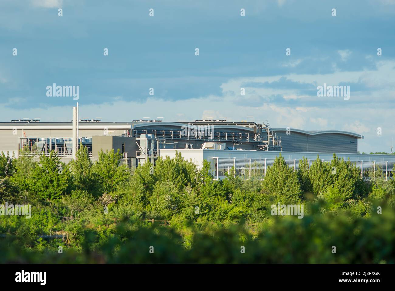 new built distribution warehouse building with farm fields in ...