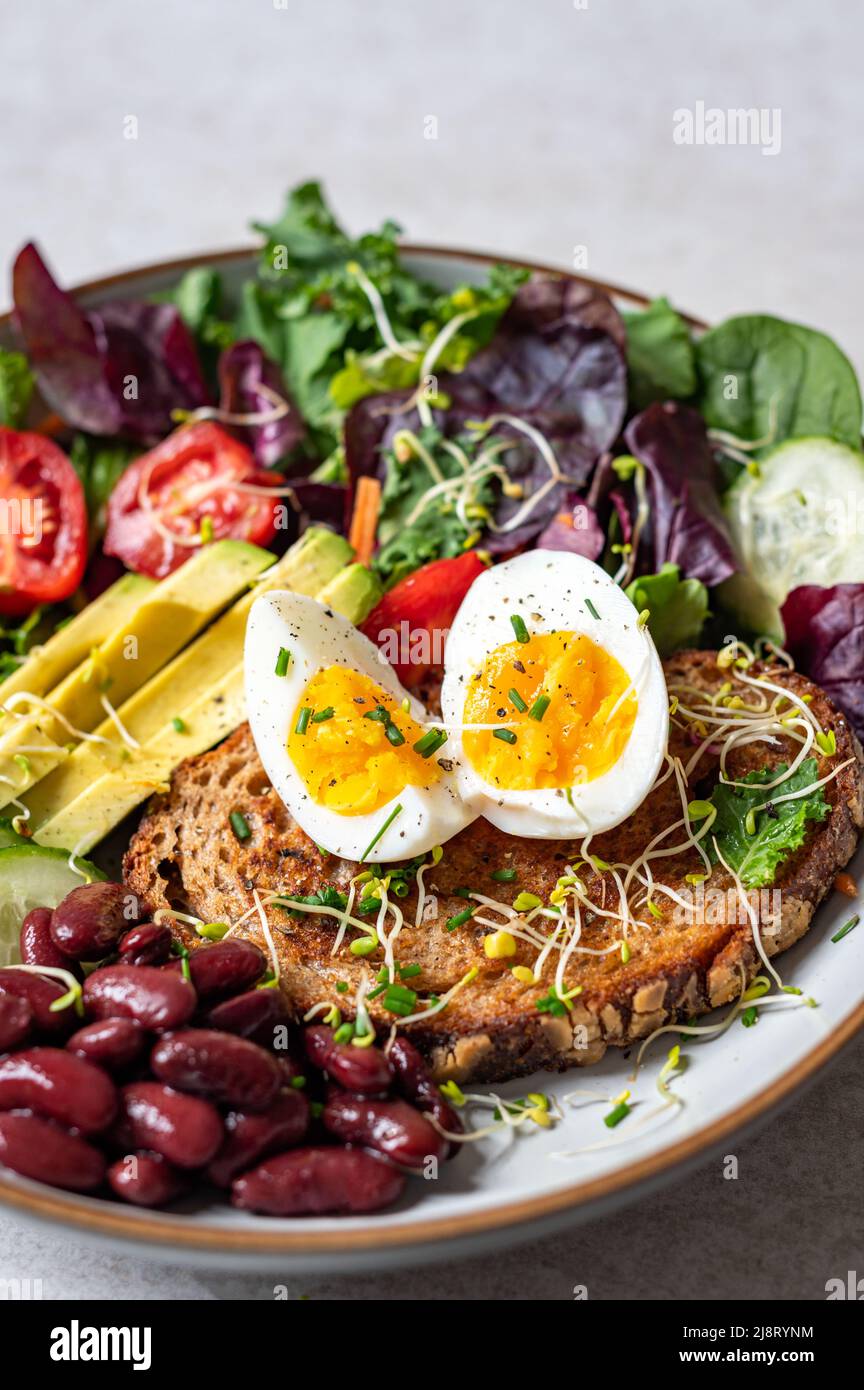 Medium boiled eggs with sasld, healthy breakfast Stock Photo - Alamy