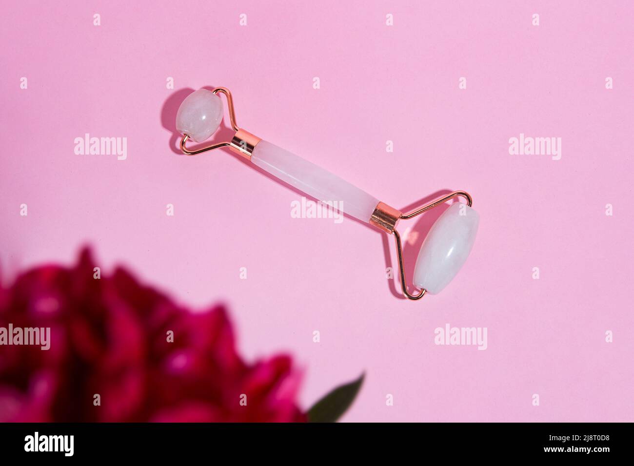 Facial roller from pink quartz,makeup concept Stock Photo - Alamy