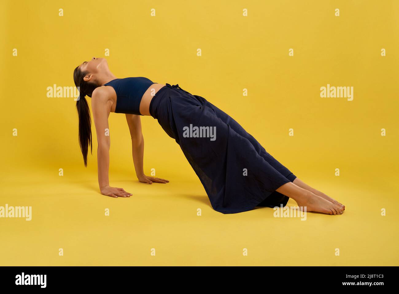 Fit caucasian girl stretching body at upward plank pose during training ...