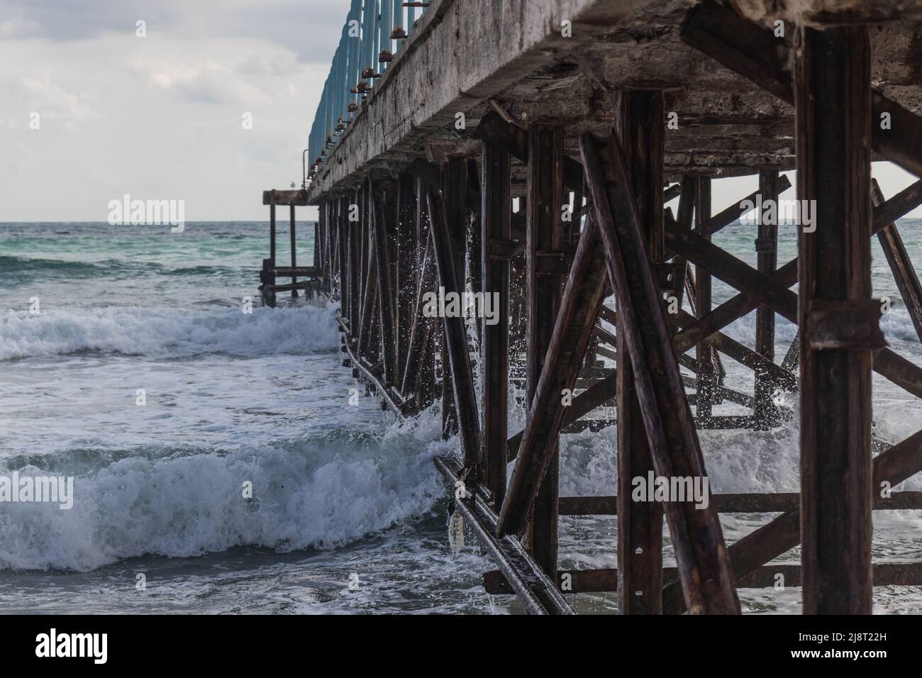 Old, abandoned jetty rotting away over the sea Stock Photo - Alamy