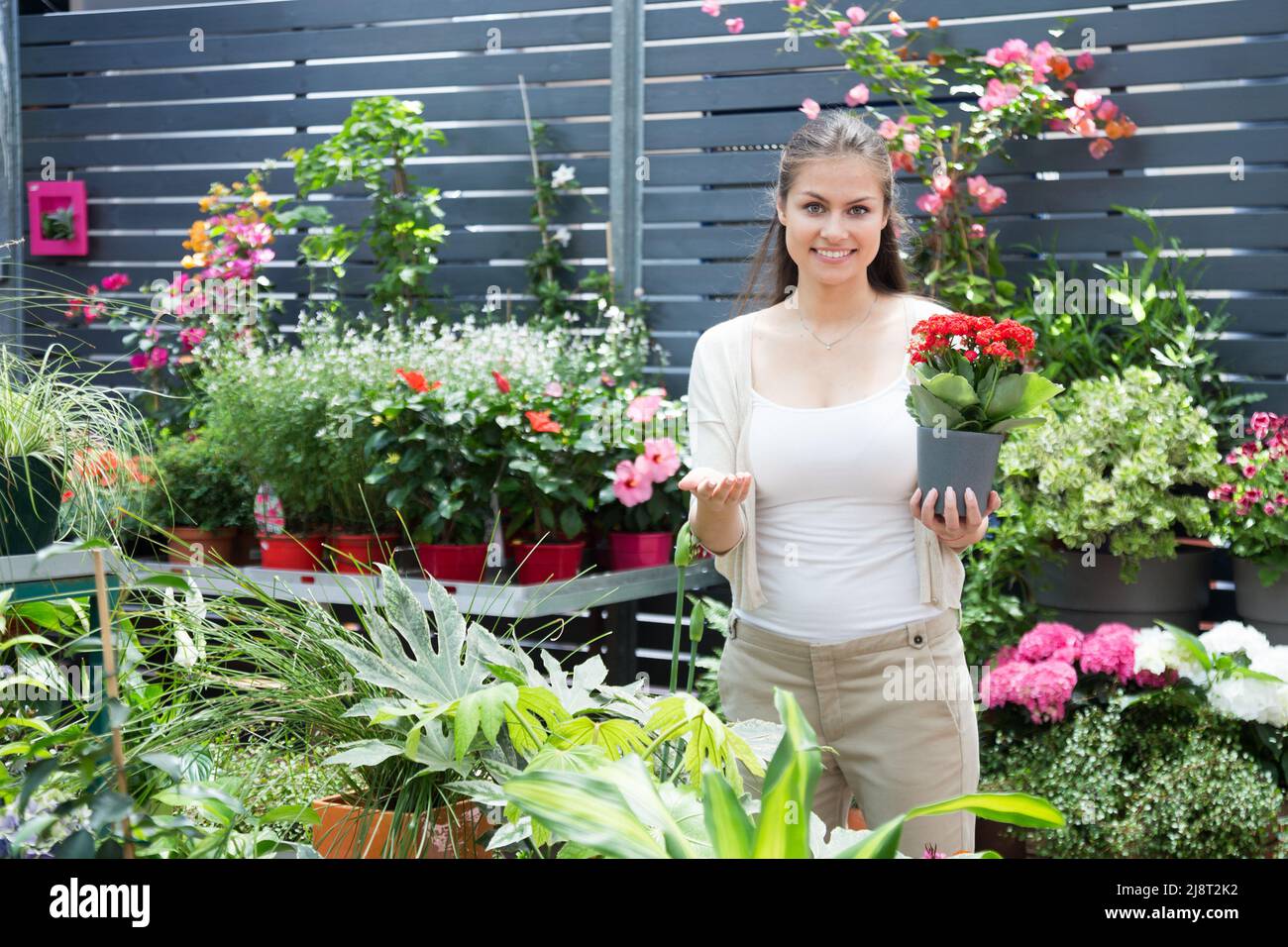 beautiful girl caring for flowers in store Stock Photo - Alamy