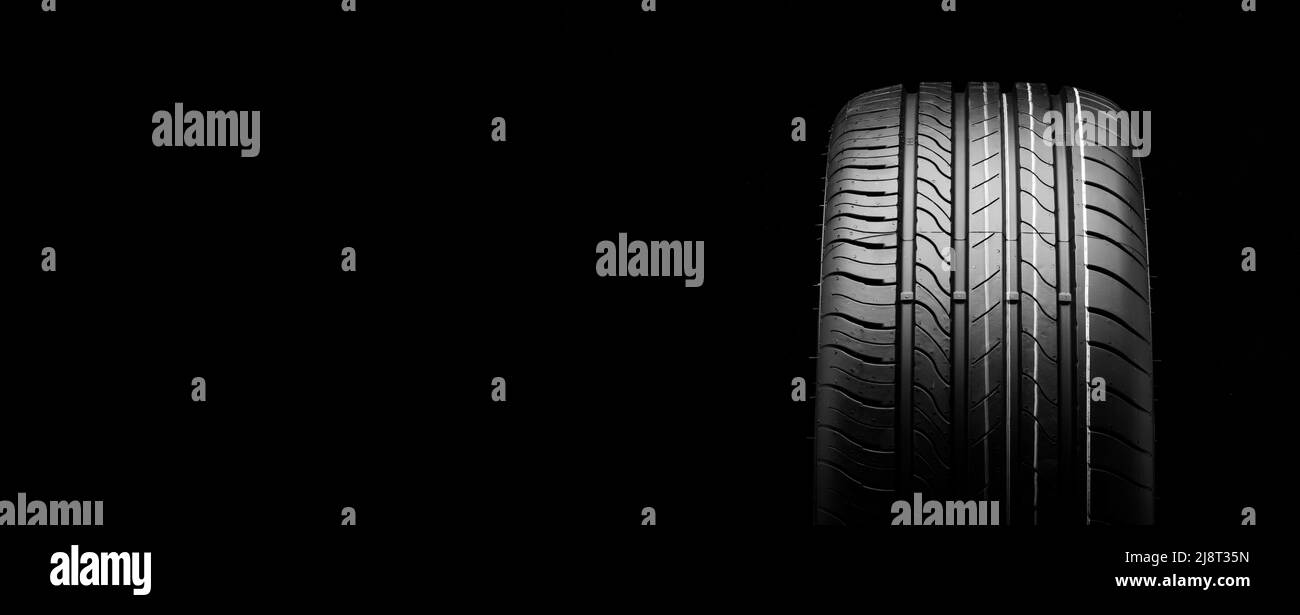 new tire on black background front view Stock Photo - Alamy