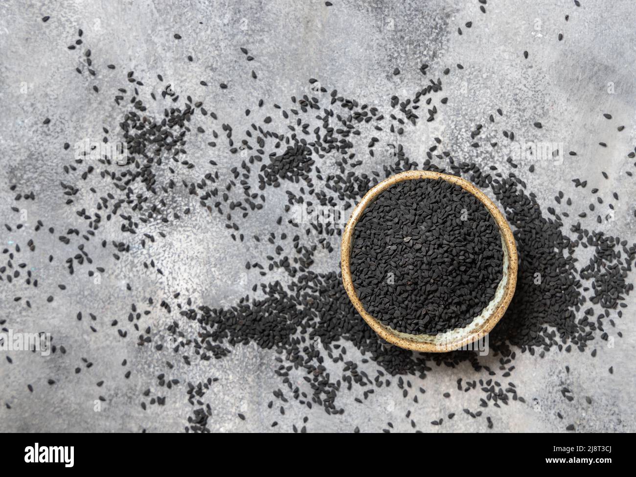 Indian spice Black cumin (nigella sativa or kalonji) seeds in bowl on ...