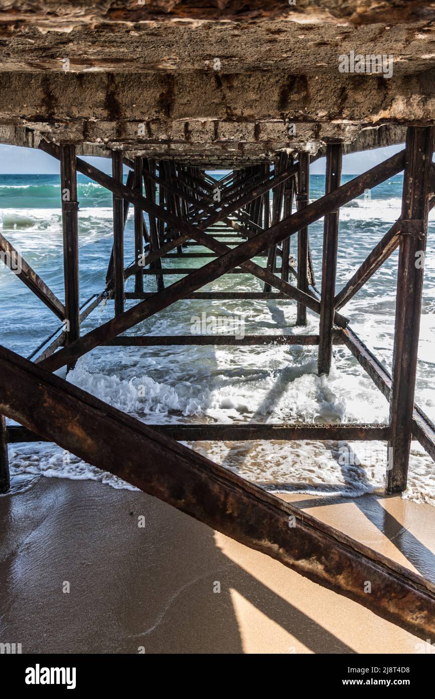 Old, abandoned jetty rotting away over the sea Stock Photo - Alamy