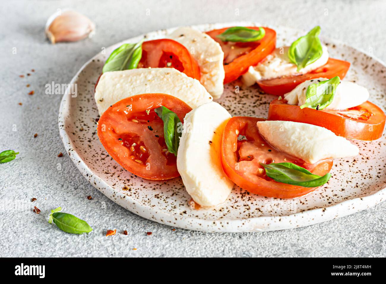 Caprese salad with juicy tomatoes, fresh mozzarella and pesto. Concept ...