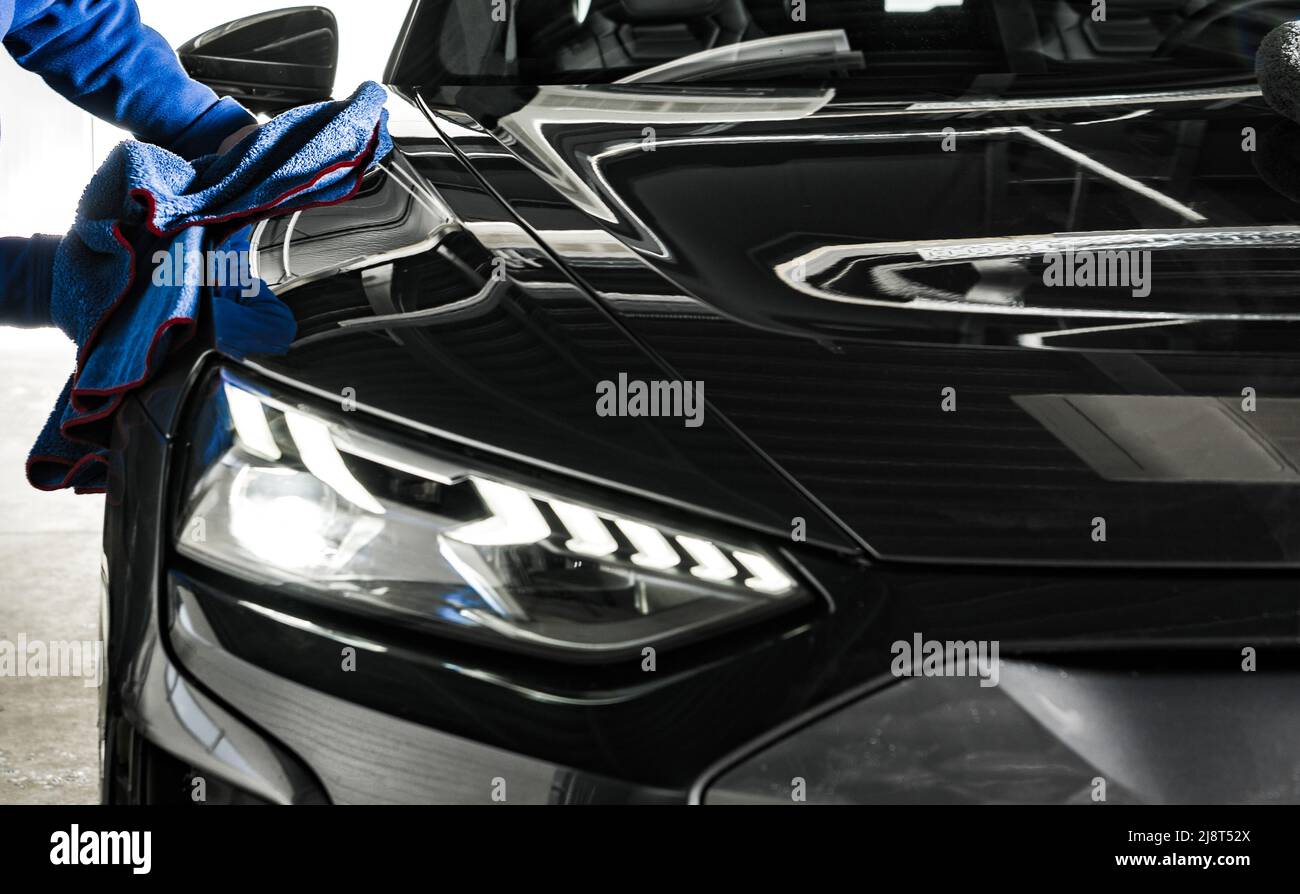 Professional Car Wash and Detailing Worker Cleaning Car Body with a a ...