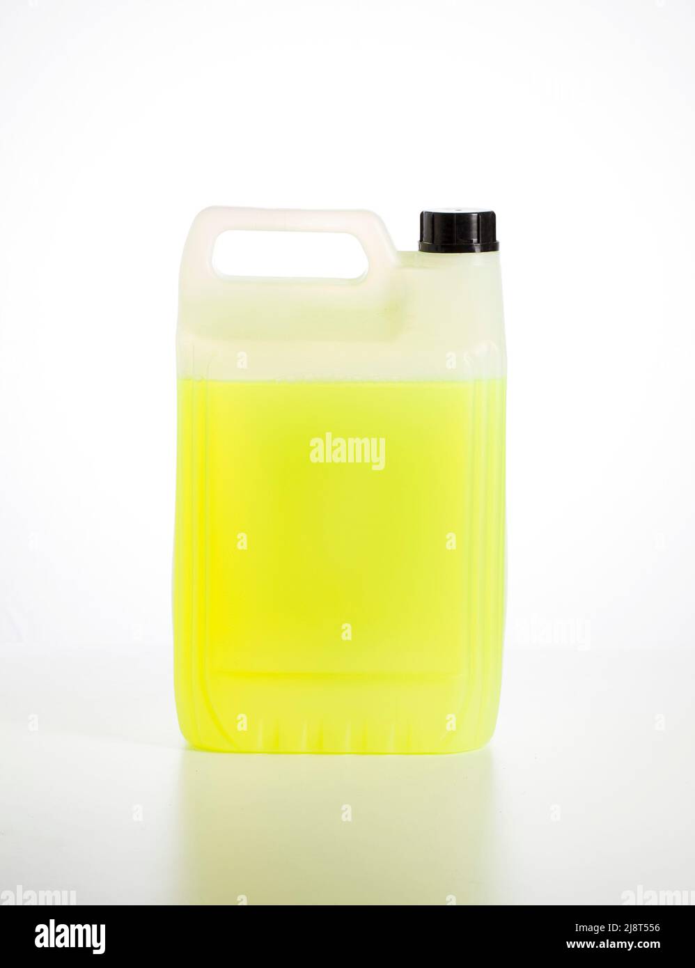 Canister with yellow car shampoo concentrate on a white background ...