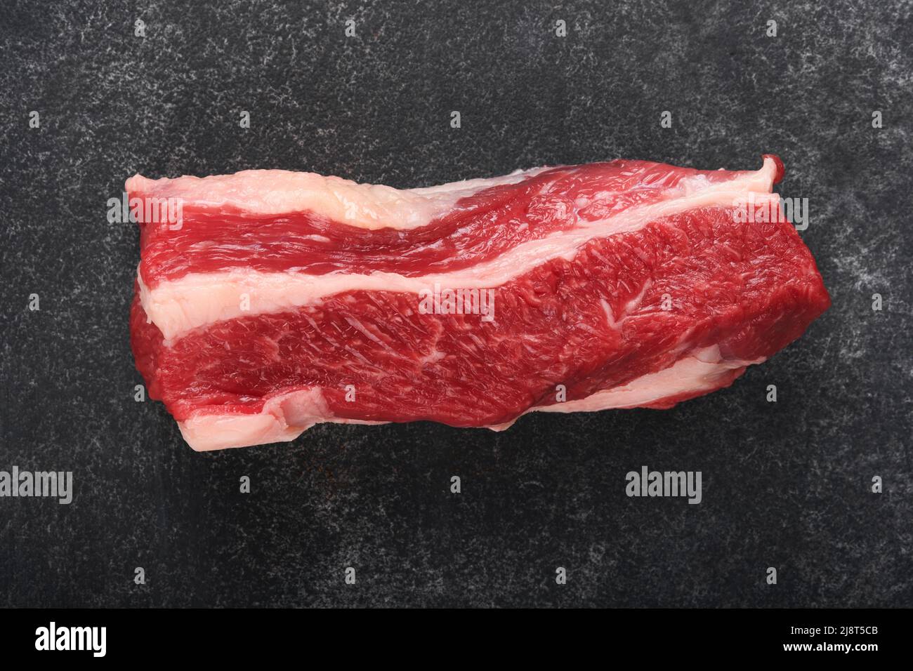 Steak beef. Raw steak New York with rosemary and spices on a piece of ...