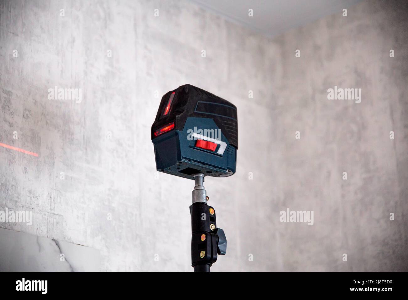 Construction laser level on the background of the wall, close-up ...