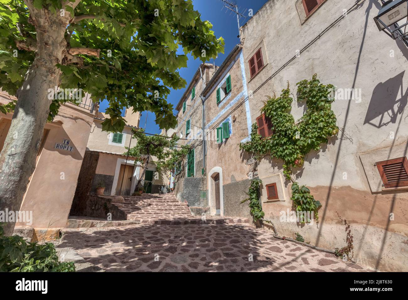 Narrow cobbled streets and stone built homes in historic Estellencs in ...