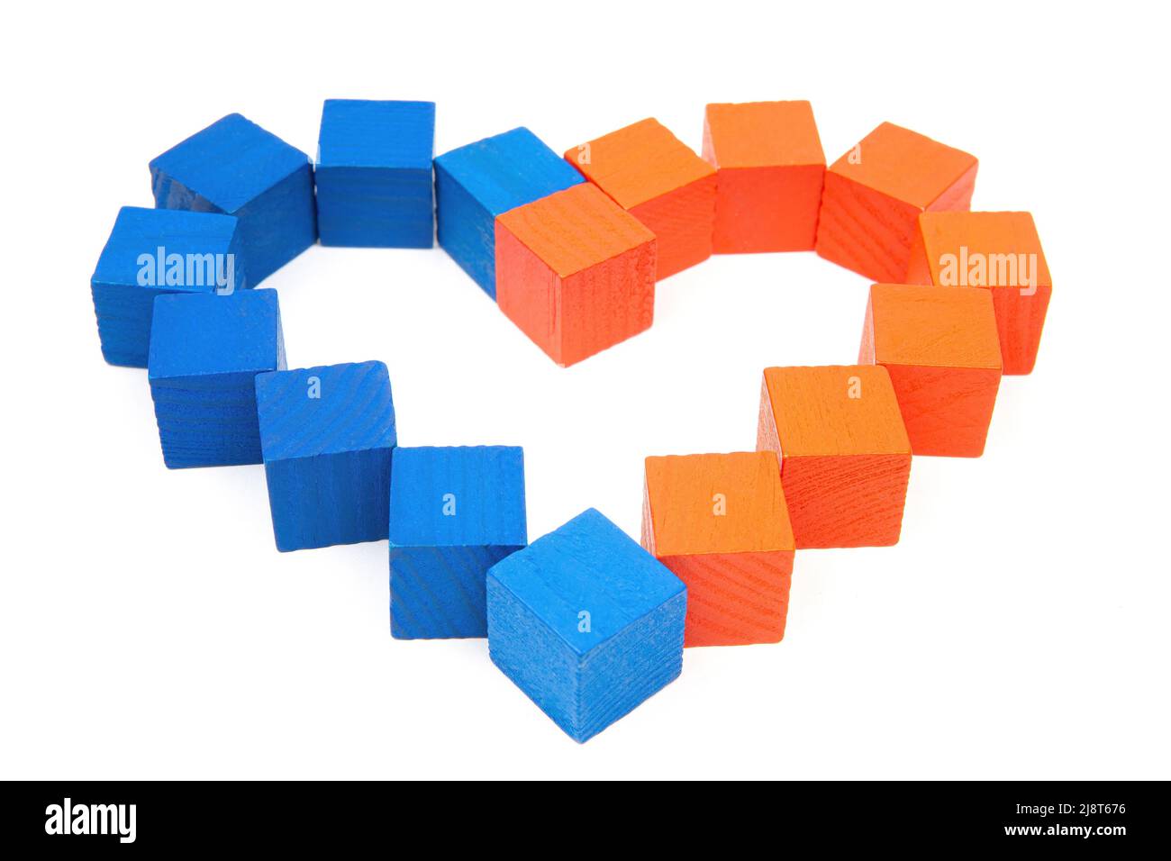 Red and blue wooden blocks shaped into a heart symbol on a white ...