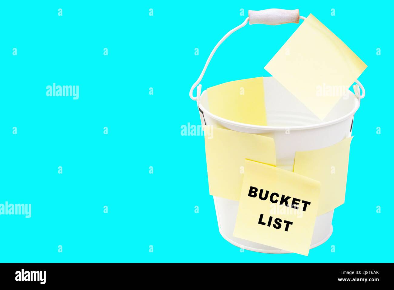 White steel bucket covered with yellow note stickers reading BUCKET ...