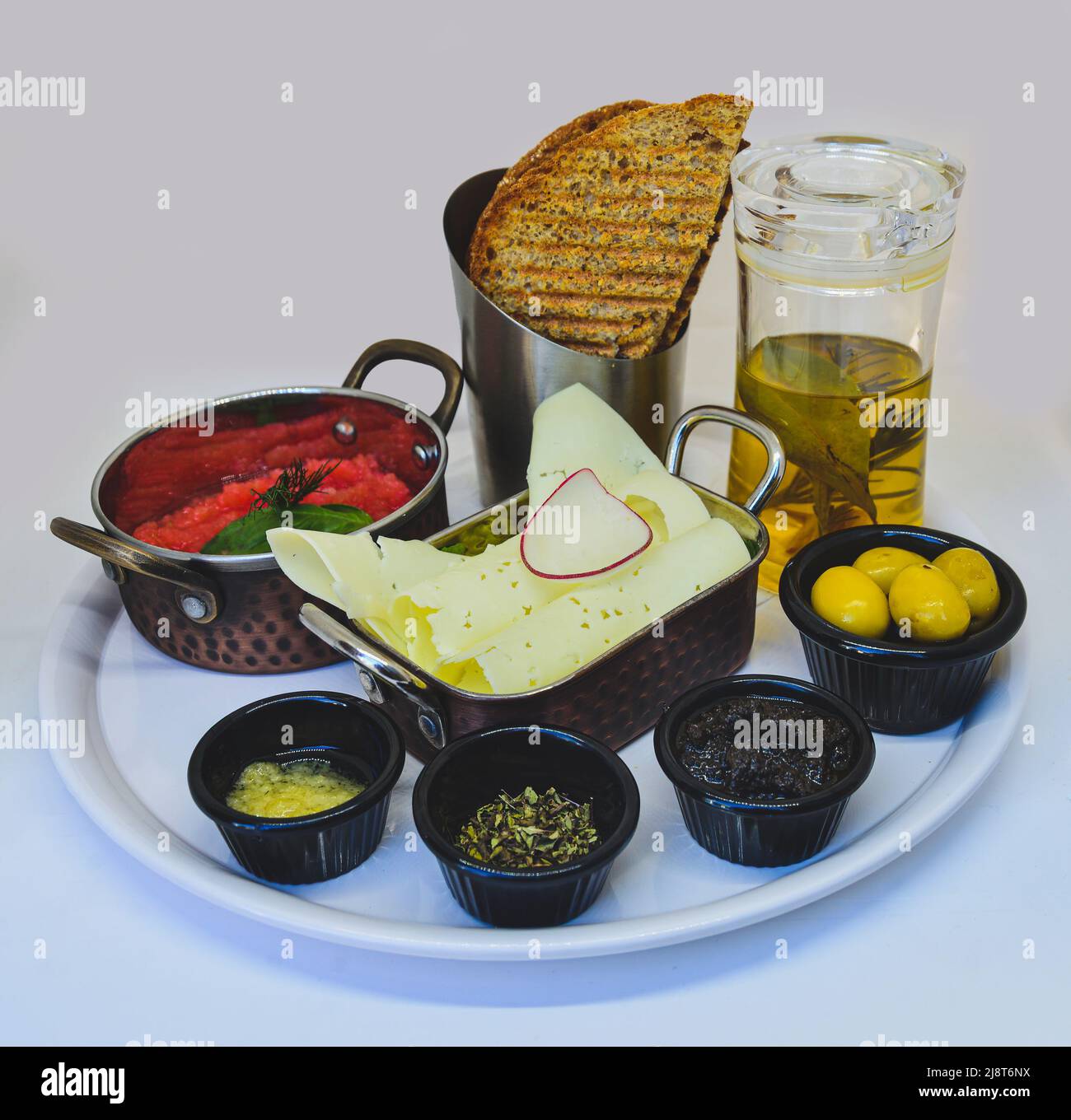 Breakfast consisting of toast, cheese, oil and olives Stock Photo - Alamy