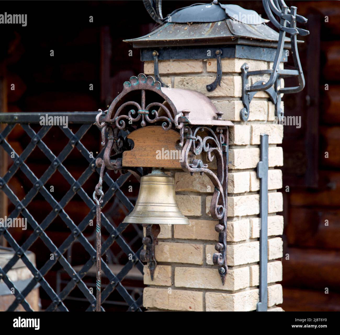 Bronze antique bell hanging at the entrance of the gate to the ...