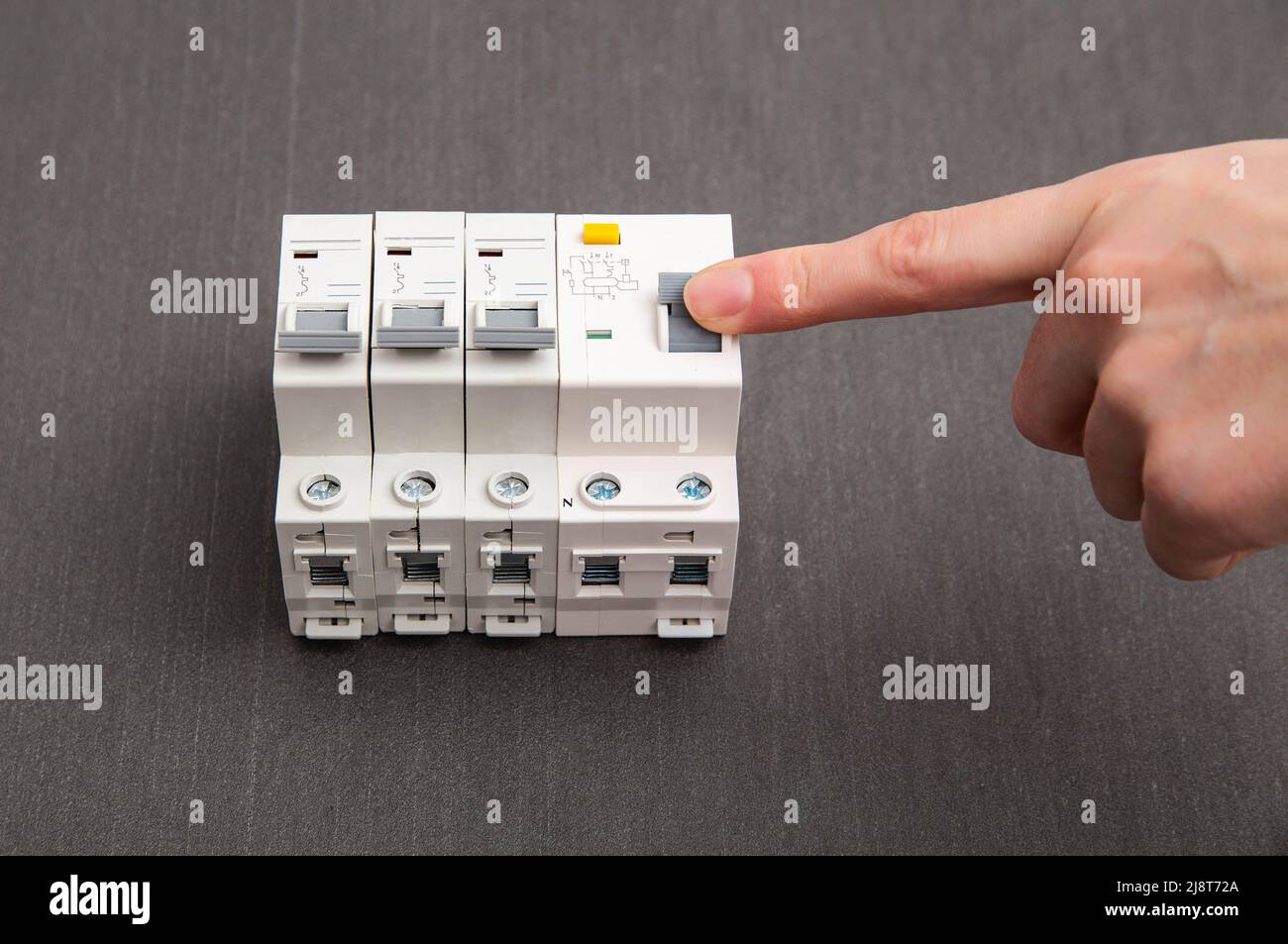 A person turns off an automatic electrical switch to disconnect the ...