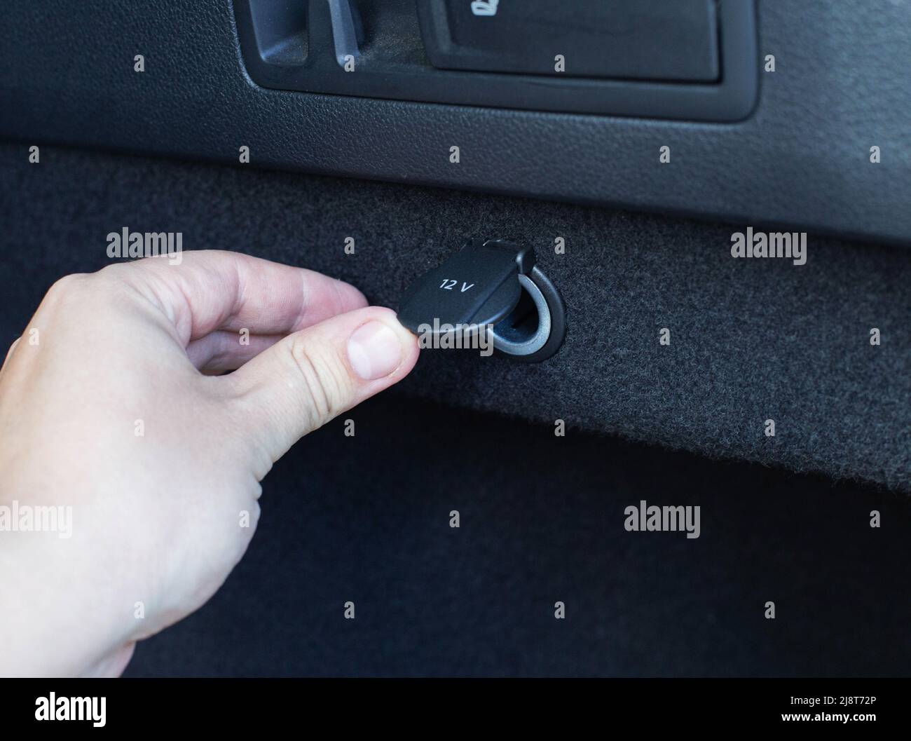 12 volt electrical outlet in the trunk of a car, close-up. Technology ...