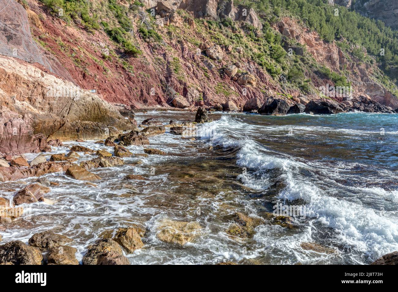 Beach at Port de Valldemossa in rocky UNESCO world heritage Serra de ...